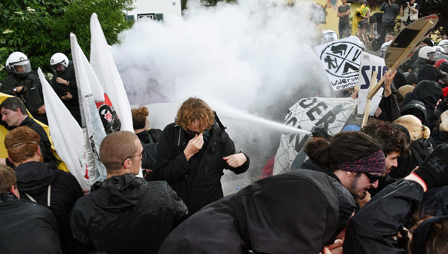 Heavy police presence for G7 as protesters stage colourful ...