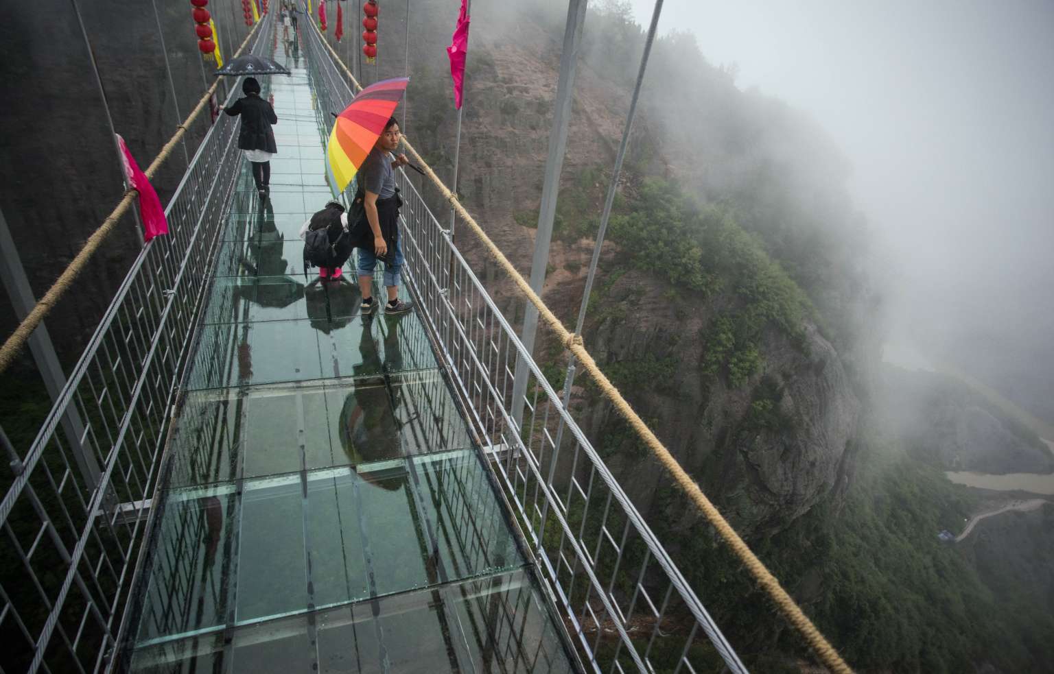 China's new glass bridges test courage of tourists, who flock there ...