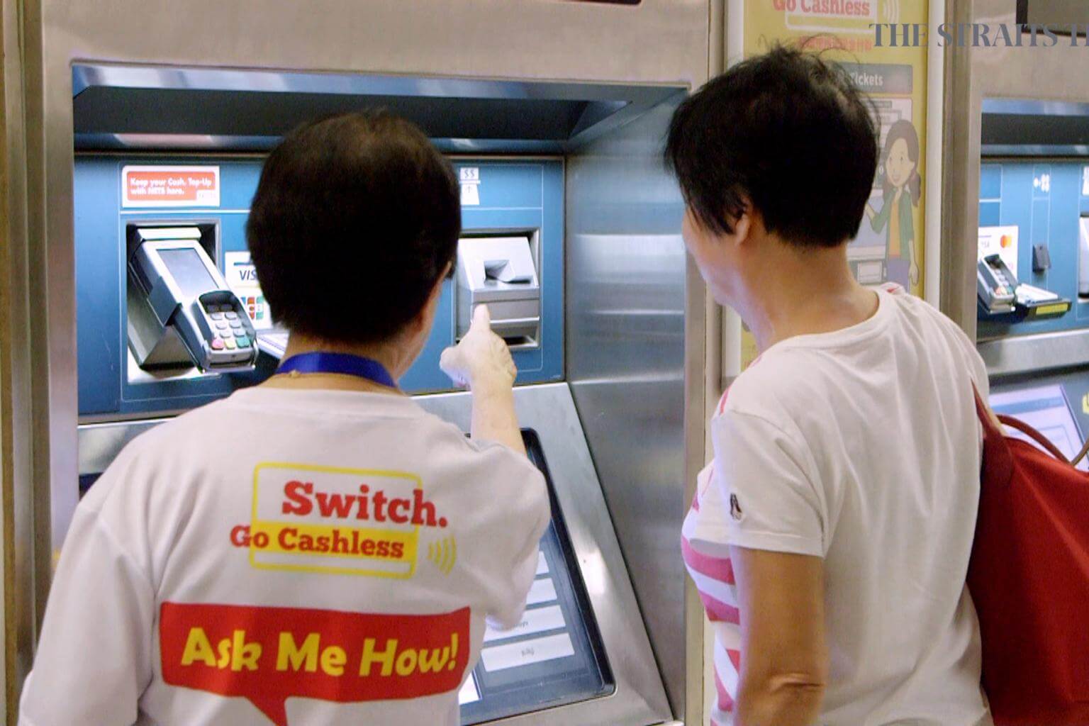 Elderly commuters learn to use machines as 11 MRT stations stop cash ...