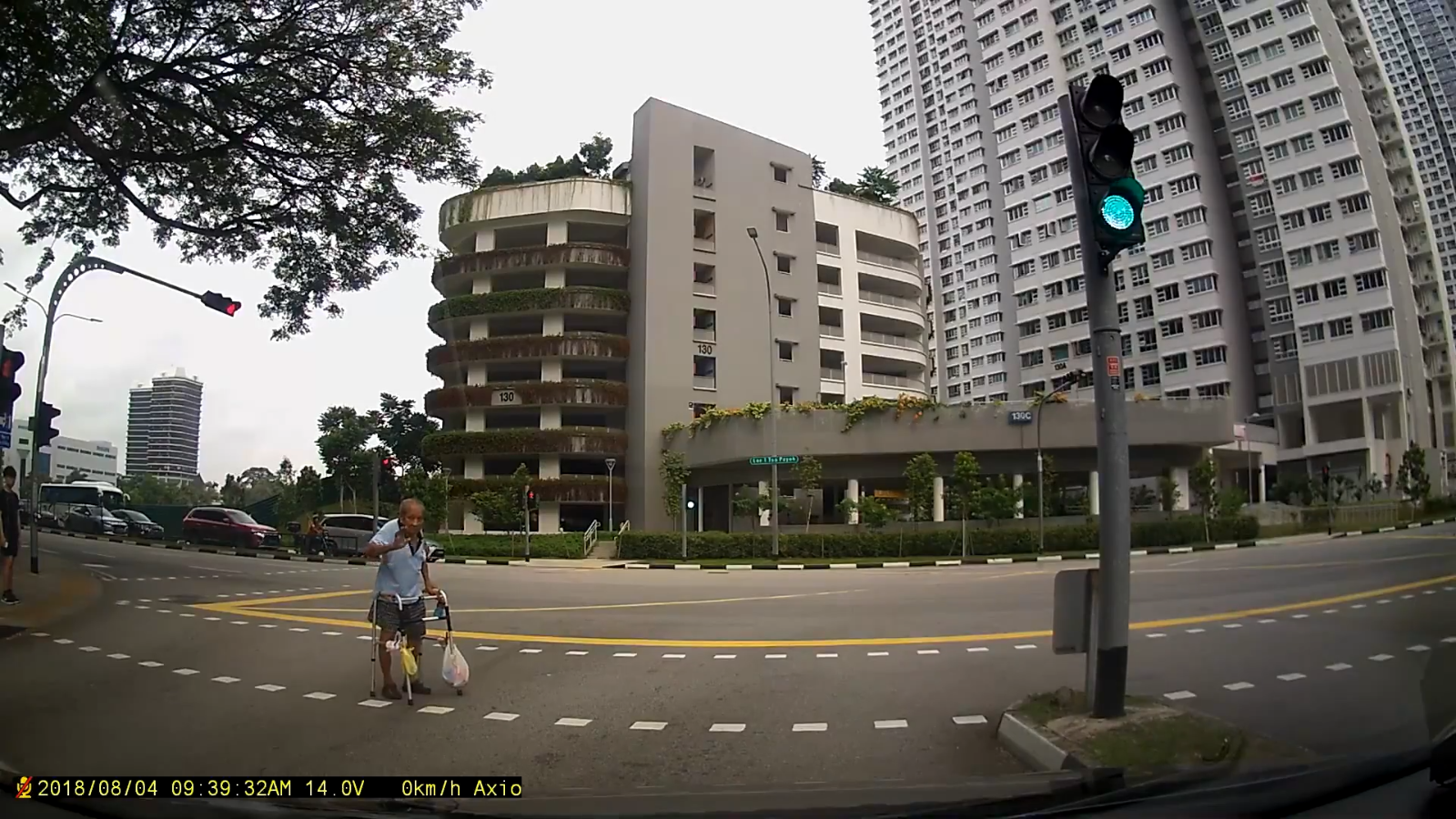 Video of elderly man crossing road as light turns green sparks ...