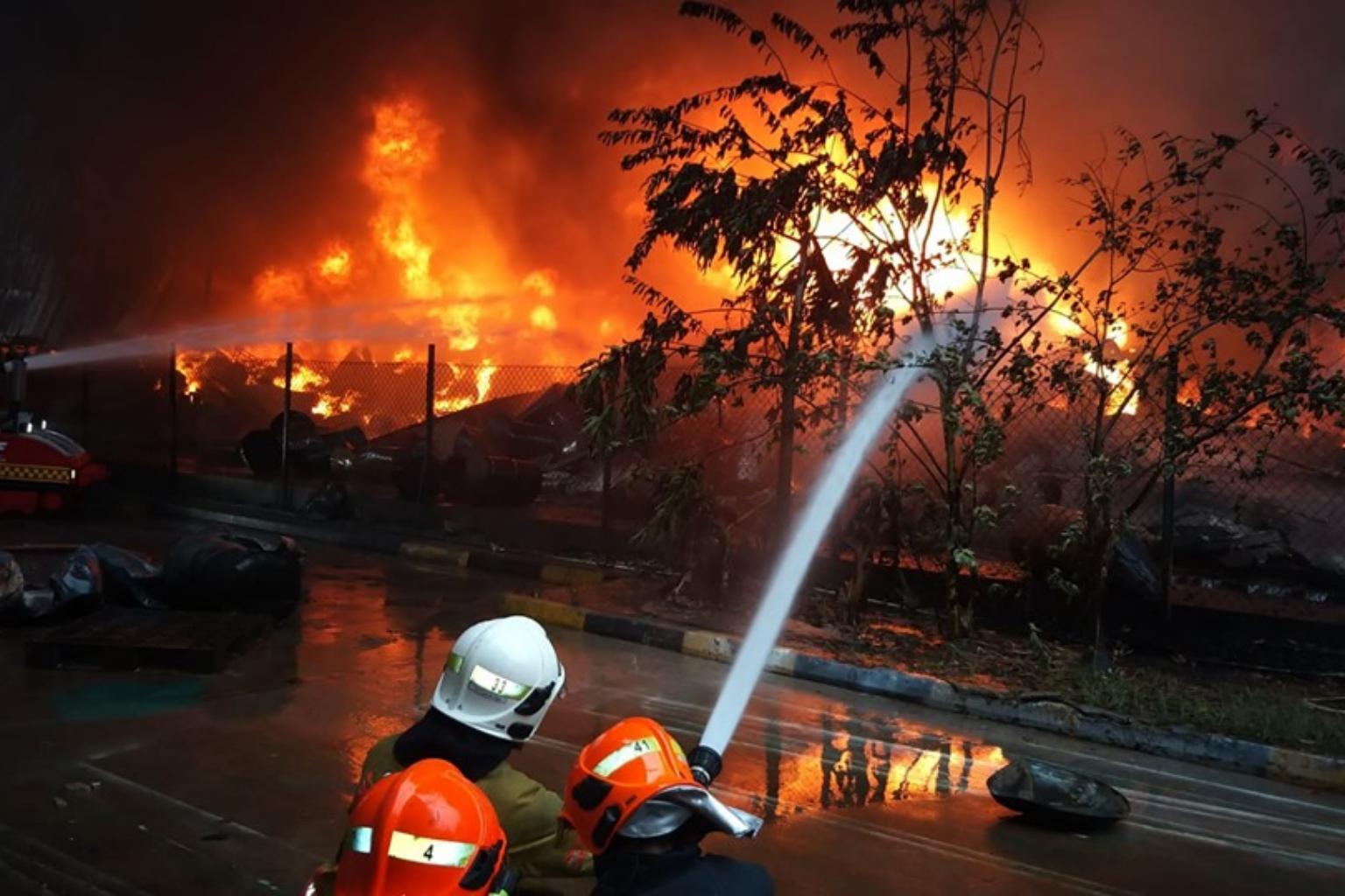 ‘Spreading along the drains’: Football field-sized fire at Tuas ...