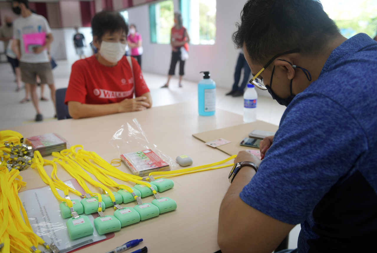 Long queues for TraceTogether tokens at Marsiling Community Club, first ...