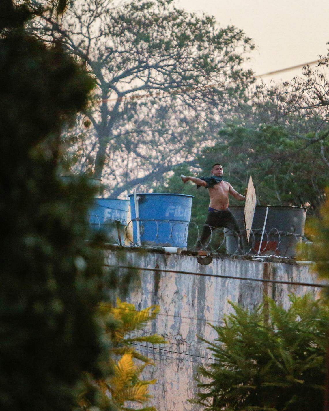 Paraguay's biggest prison set ablaze, rioting inmates take guards ...