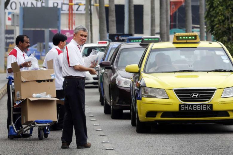 Taxi association hands out 2,500 haze readiness kits to cabbies at the ...