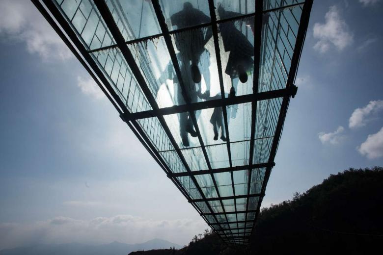 China's new glass bridges test courage of tourists, who flock there ...