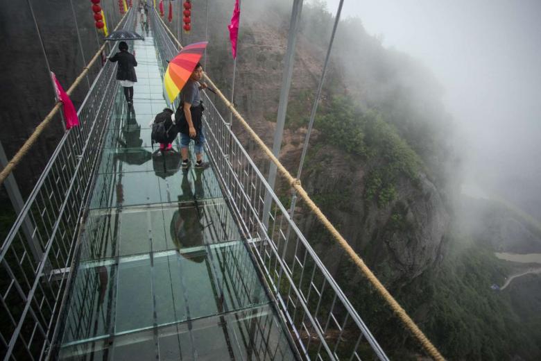 China's new glass bridges test courage of tourists, who flock there ...