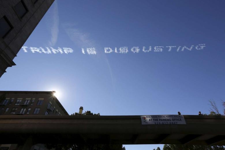 Skywriting planes take to the sky over California parade, writing anti ...
