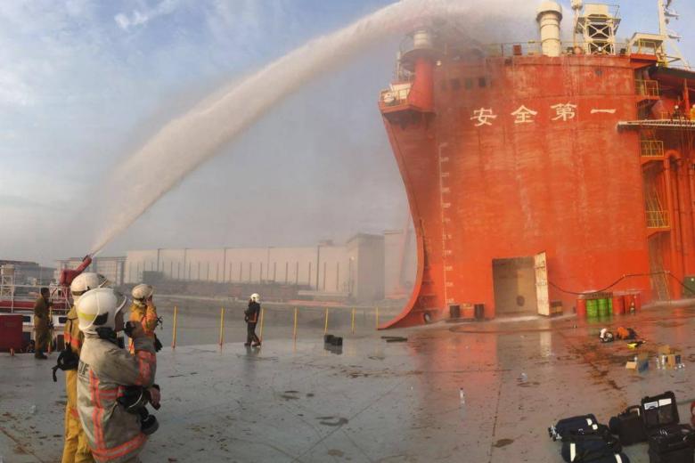 Firefighter injured in 7-hour operation to put out fire on cargo barge ...