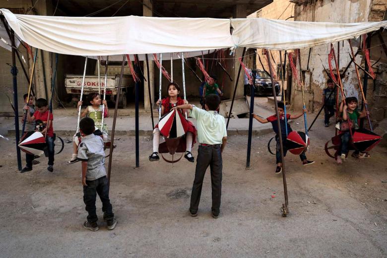 Besieged Syrian kids play with swings made of rockets | The Straits Times