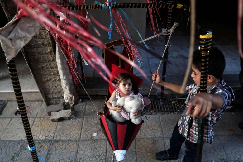 Besieged Syrian kids play with swings made of rockets | The Straits Times