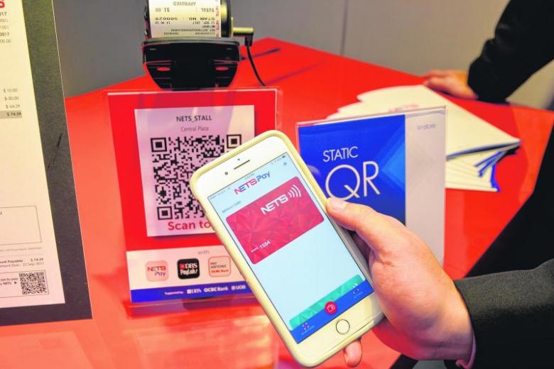 Customers of major banks here can soon use Nets' QR code system to pay ...
