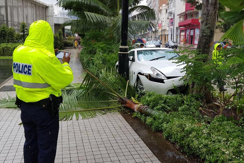 Car crashes into tree, lamp post near Dhoby Ghaut MRT station; driver ...