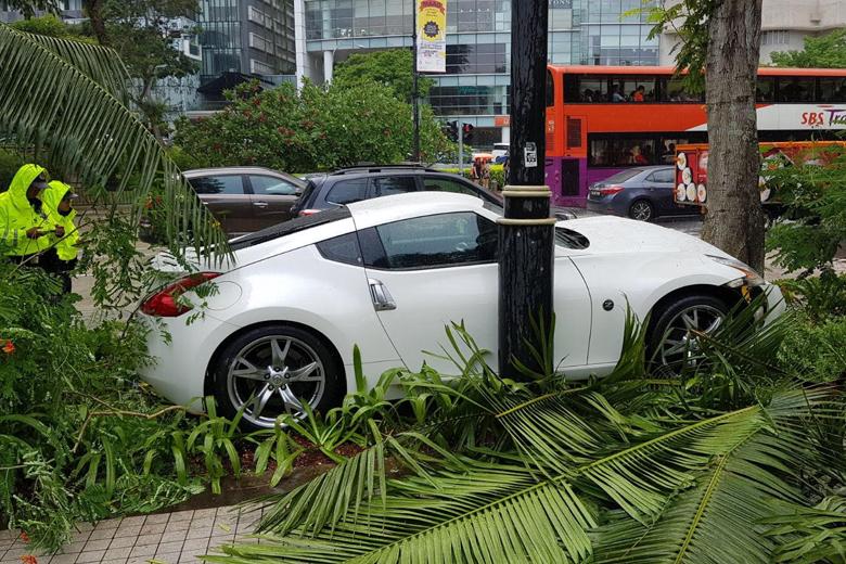 Car crashes into tree, lamp post near Dhoby Ghaut MRT station; driver ...