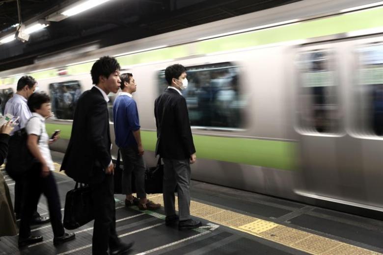 Overworked Japan caps overtime at 100 hours a month | The Straits Times