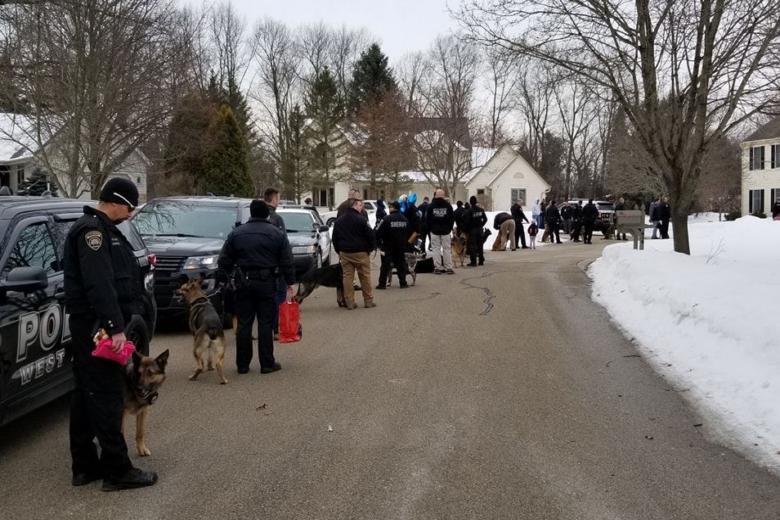 Long queue of dogs from US K-9 unit wait to surprise girl with brain ...