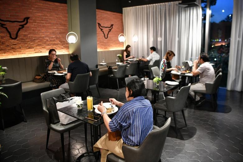 Restaurants slowly filling up as bookings trickle in after S'pore eases ...