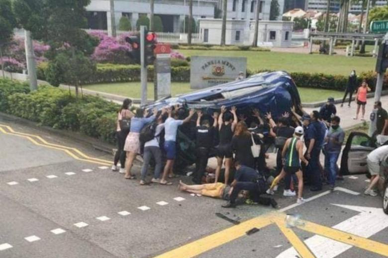 About a dozen people lift car outside Parliament House to help accident ...