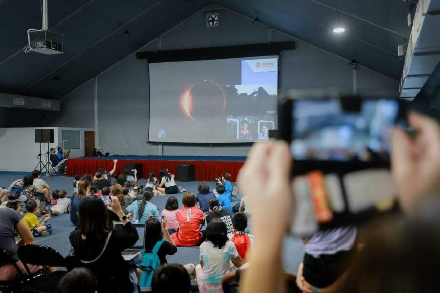 Rare hybrid solar eclipse obscured by rain clouds in Singapore | The ...