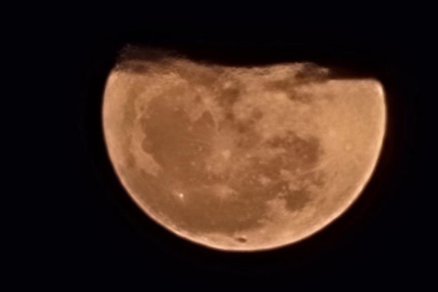 Singaporeans delighted to see supermoon on cloudy night | The Straits Times