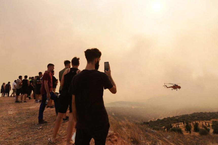 Wildfire rages north-west of Athens unabated, burns homes | The Straits ...