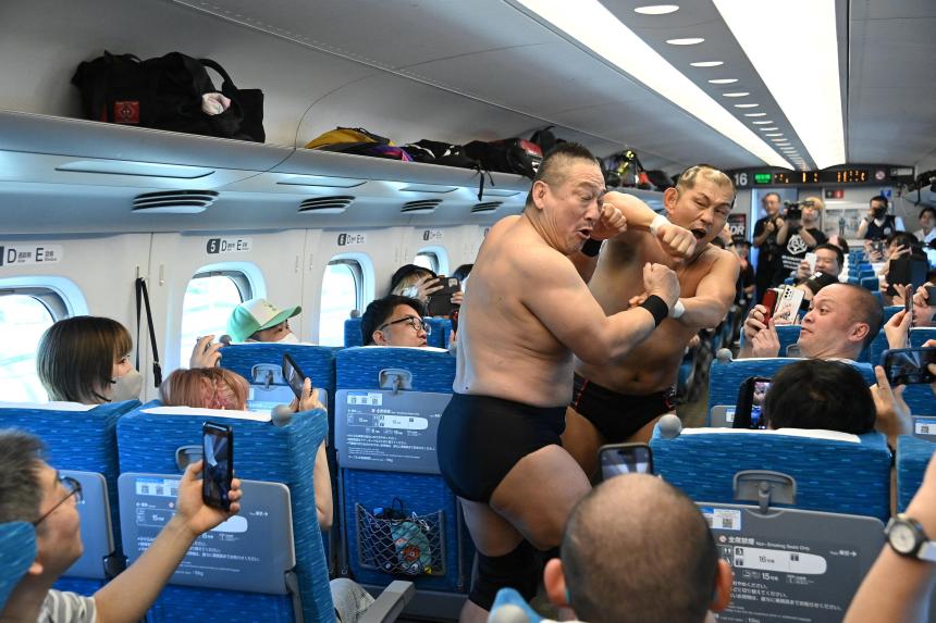 Japanese wrestlers in all-out high-speed brawl entertain passengers on bullet train | The ...