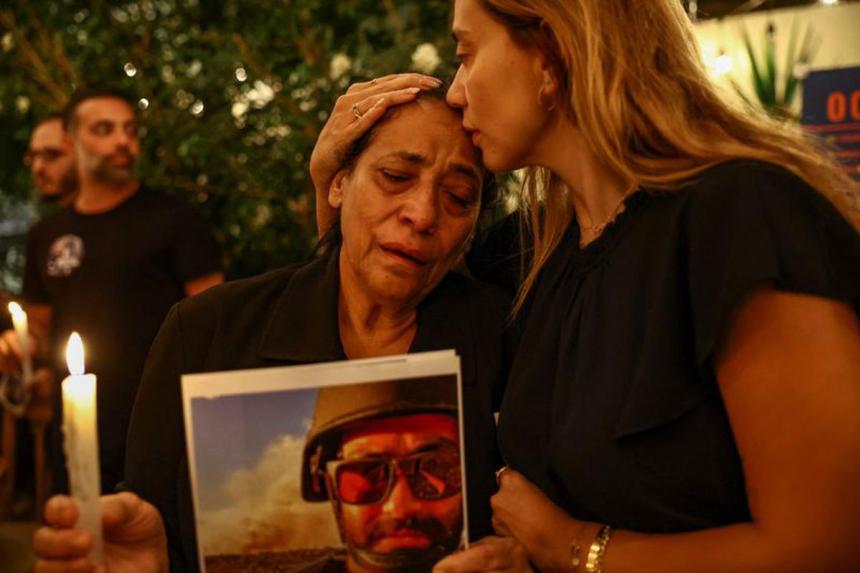Friends, relatives hold vigil for fallen Reuters journalist Issam ...