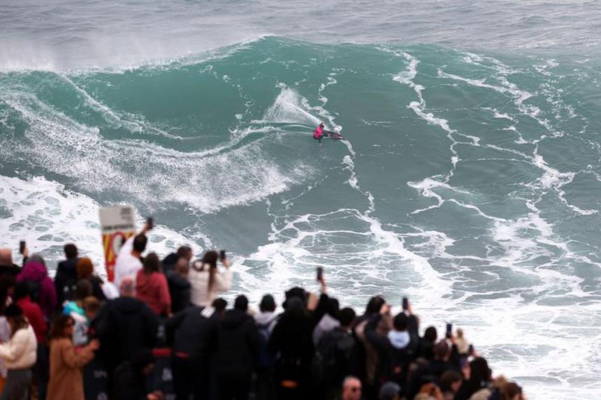 Surfers take on giant waves in Portugal as extreme weather hits Europe ...