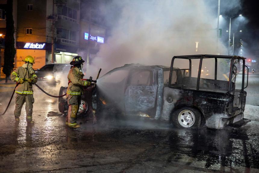 Protesters set fire to two patrol cars in southern Mexico | The Straits ...