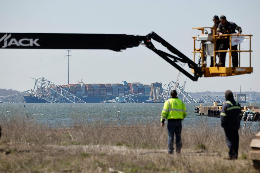 Huge crane in place to clear Baltimore bridge debris as crews assess ...