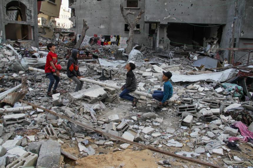 Children play in rubble of Gaza for Eid holiday | The Straits Times