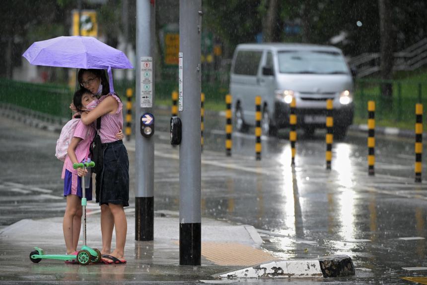 Heavy rain prompts flood warnings for many areas of Singapore, delays ...