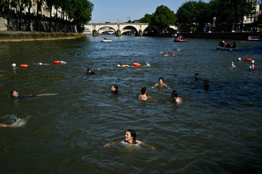 Paris mayor swims in Seine to show it’s safe for Olympic races | The ...