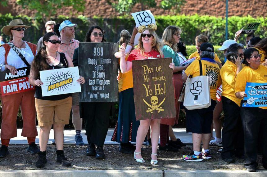 Disneyland workers in US threaten strike action over wages, treatment ...